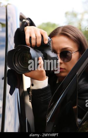 Private detective with camera spying near building on city street Stock ...