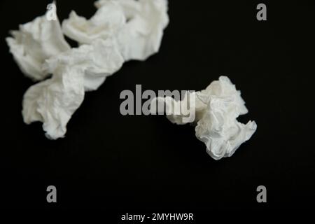 Used white paper tissues on black background Stock Photo - Alamy