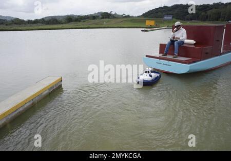 A Panama Canal pilot maneuvers a miniature tugboat during a training ...