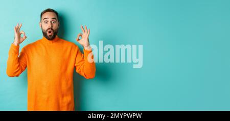 Impressed man praising something super cool, showing okay sign and ...
