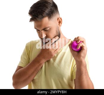 Stressed young man squeezing ball at home Stock Photo - Alamy