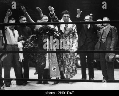 Max Schmeling, right, and his attendants give the Nazi salute after the ...