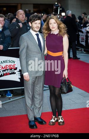 Iwan Rheon and Zoe Grisedale pose for photographers upon arrival at the ...
