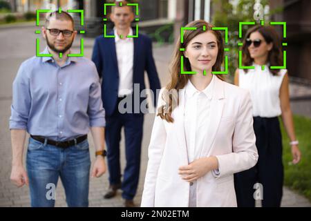 Facial recognition system identifying people on city street. AI giving ...