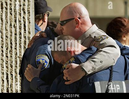 California Highway Patrol Officer Rob Cullinan, right, rings the bell ...