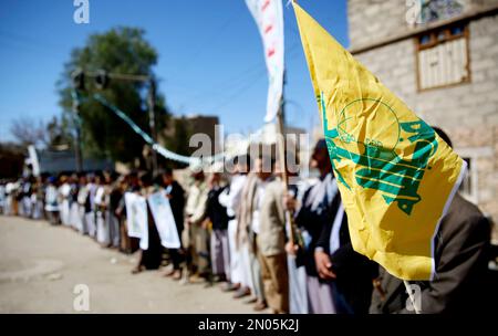 Shiite rebels known as Houthis, hold Palestinian flags during a rally ...