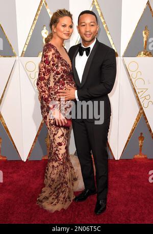 Christine Teigen, left, and John Legend arrive at the Oscars on Sunday ...