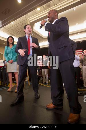Sen. Tim Scott, R-S.C., right looks on as state Rep. Bruce Bannister, R ...