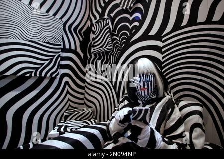 Model feebee poses as part of an art installation “Dazzle room” made by ...