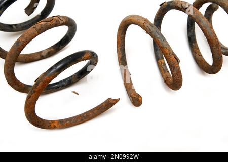 The old rusty broken coiled spring from the car suspension isolated in ...