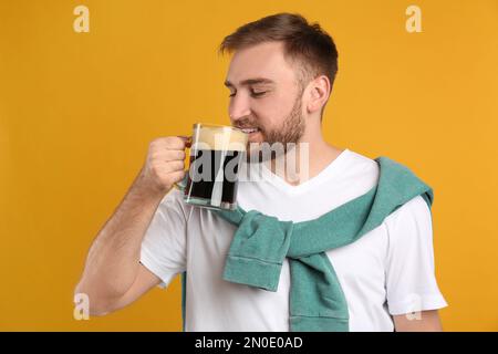 Handsome man with cold kvass on white background. Traditional Russian ...