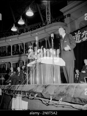 American evangelist Billy Graham speaks with the native women of a ...