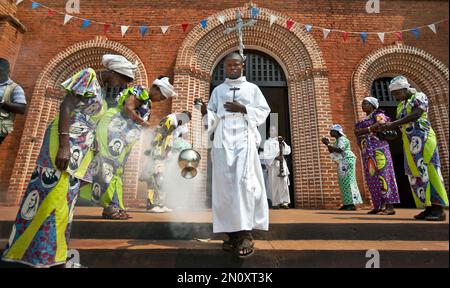 The thurifer swings the thurible of incense as he leads the procession ...
