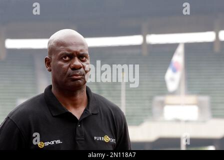 Canada's former sprinter Ben Johnson poses for the media next to a 100 ...