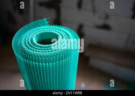 New roll of green reinforcing mesh close-up. Plaster mesh for wall ...