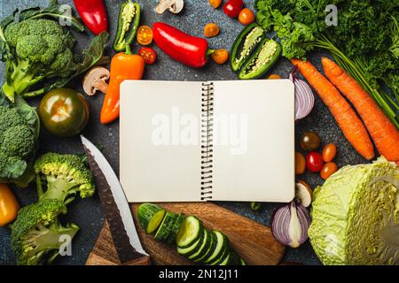 fresh vegetables, cutting board, notepad and smart phone on table Stock ...