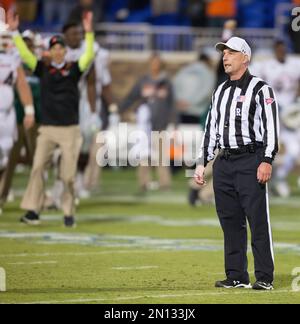 College football referee Jerry Magallanes stands on the field during ...