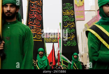 Bahraini men participate in a Shiite Muslim religious procession using ...