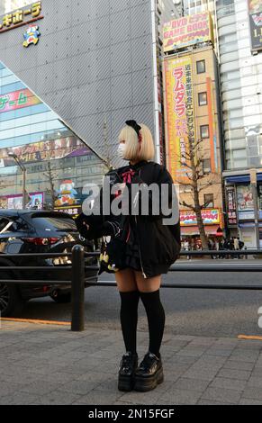 Girls dressed in French maid costumes handing out discount coupons for ...