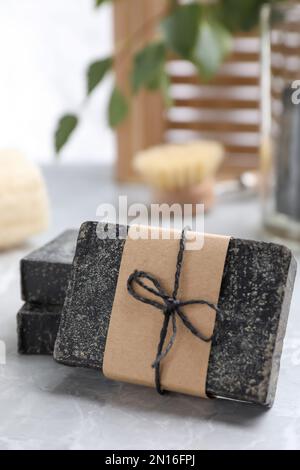 Natural tar soap on light grey table Stock Photo - Alamy