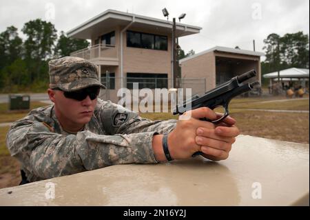 A member of the 139th Military Police Company shoots his 9mm Beretta M9 ...