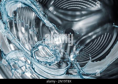 Washing machine drum with water splash Stock Photo - Alamy