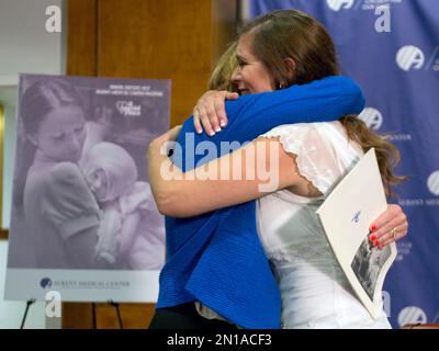 Nurse Susan Berger, left, and Amanda Scarpinati pose with a copy of a ...
