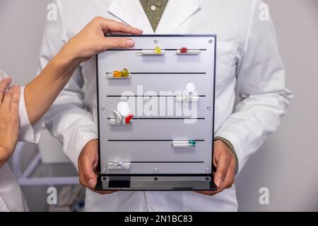 Two ent doctors demonstrating innovative hearing aids Stock Photo - Alamy
