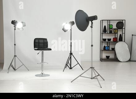Interior of modern photo studio with shelving units, couch and ...