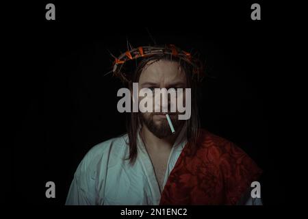 Jesus Christ smokes a cigarette wearing a crown of thorns and white ...
