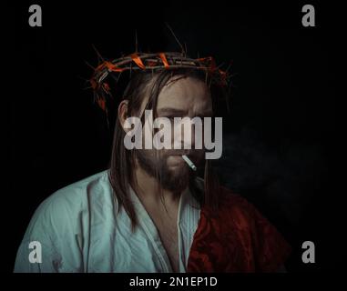 Jesus Christ smokes a cigarette wearing a crown of thorns and white ...