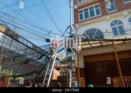Kathmandu Nepal Worker fixing intricate communication wires cables ...