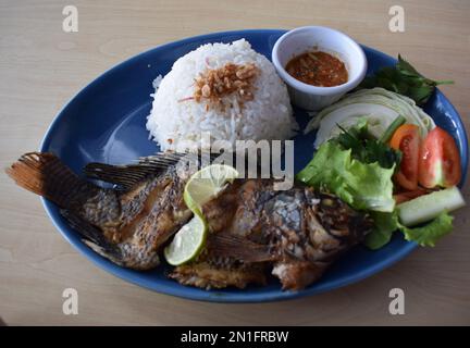 Delicious fried tilapia with white rice served on the table Stock Photo ...