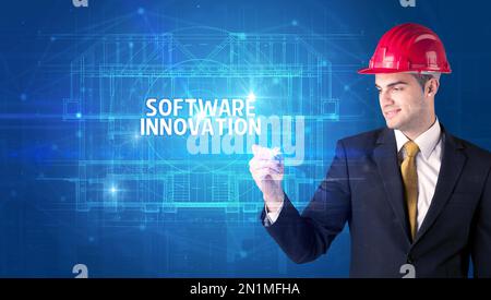 Handsome architect with helmet drawing SOFTWARE UPDATE inscription, new ...