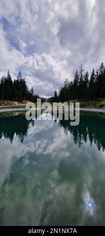 Clouds reflected in calm pond Stock Photo - Alamy