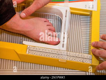 Netherlands, Arnhem . Measuring children's feet in a shoe store Stock ...
