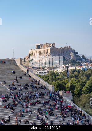 A picture of a crowded Panathenaic Stadium, and the Acropolis of Athens ...