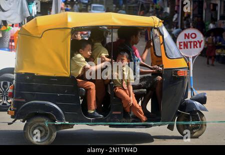 Indian auto rickshaw on a school run with young schoolboys and ...