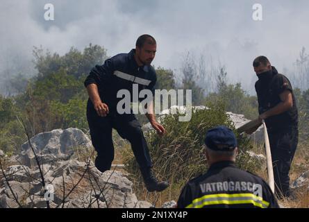 Croatian fire workers controls fire during forest fire on the Peljesec ...