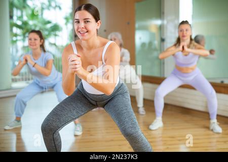 Group are practising arch movement in step jazz dance in fitness gym ...