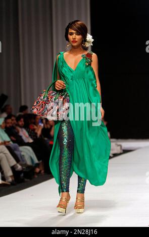 Model on the catwalk shows the Pakistani traditional dress, a sari, at ...