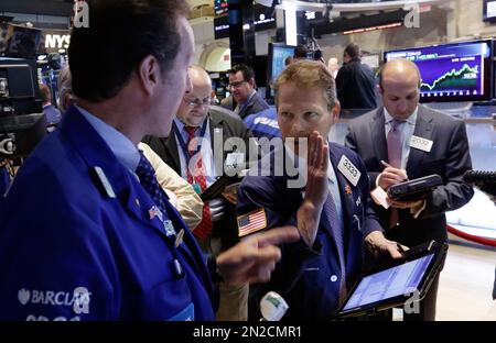 Trader Robert Charmak, center, works on the floor of the New York Stock ...