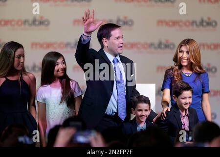 Republican Marco Rubio, left, waves after winning his Senate bid ...