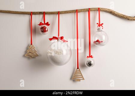 Decorative snow globes hanging on grey background Stock Photo - Alamy