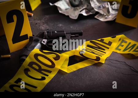 Composition with gun on black slate table, closeup. Crime scene Stock ...