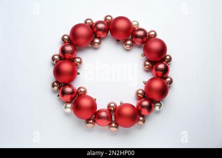 Frame made of beautiful Christmas balls on red background, top view ...