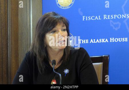 House Majority Leader Charisse Millett, R-Anchorage, left, helps pin a ...