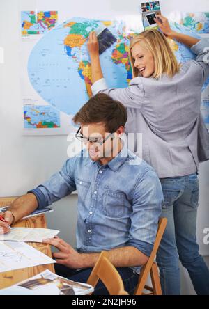 Smiling guy deciding on best sausage in food shop Stock Photo - Alamy