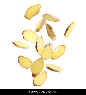 Fresh sliced ginger falling on white background Stock Photo - Alamy