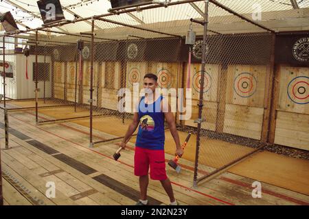 Axe throwing man Stock Photo - Alamy